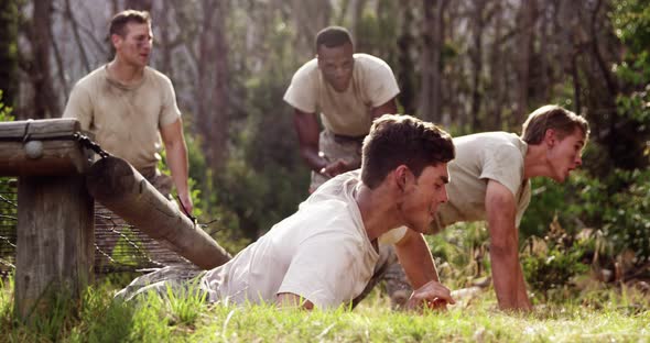 Military soldiers crawling under the net during obstacle course 4k ...