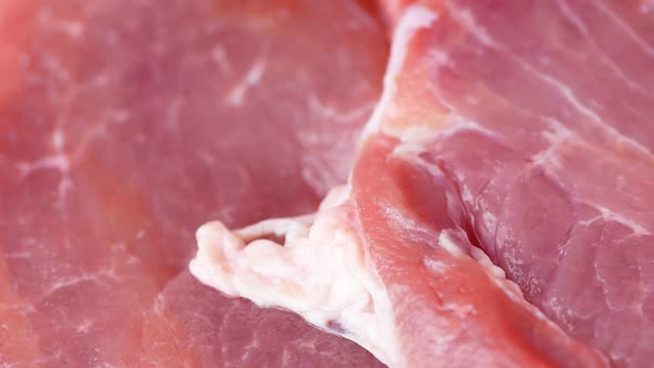 Close-up of pieces of fresh raw red meat rotate. Meat delicacies. Pork ...