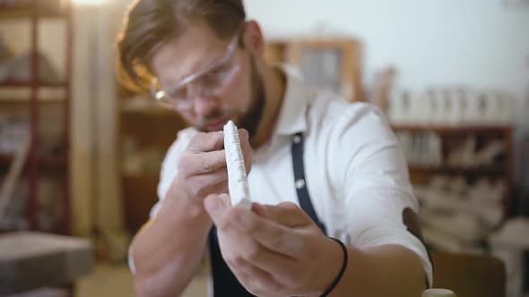 Young Bearded Master with Fashion Haircut Checking the Detail to the ...
