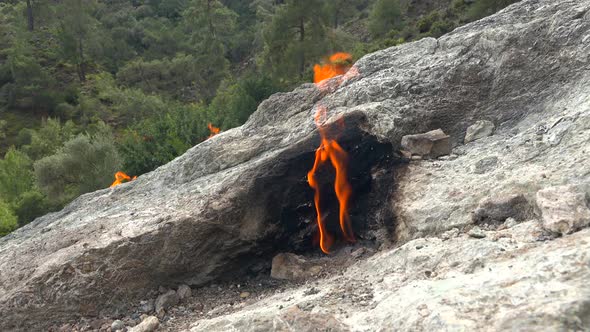 Flame of Methane Underground Emerges From Crack Between Rocks and Burns ...