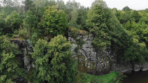 Aerial View of Steep Cliff on Rivers Edge With Thick Surrounded by ...