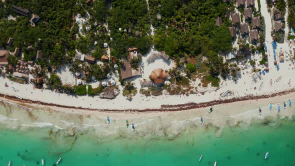 Establisher Shot of Busy Tropical Beach with Clear Ocean Empty Boats ...