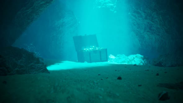 A treasure on the seabed in a secret underwater cave. Pirate chest in ...