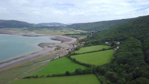 Wide aerial tracking forward over the village of Porlock Weir, and ...