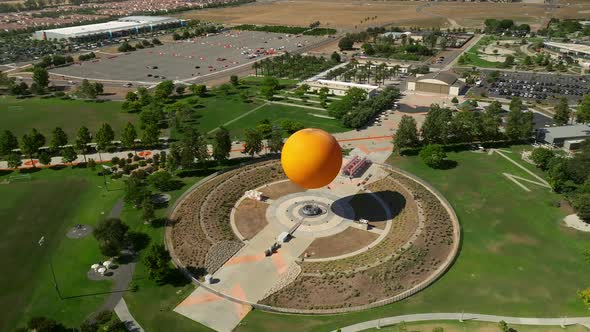 Circling aerial view of the Orange balloon ride at the great park ...