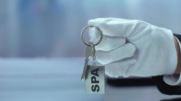 Lady Taking SPA Keys From Receptionist in Glove, Relaxation in Wellness ...