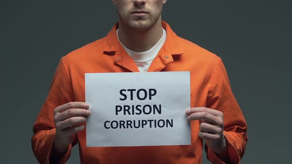 Stop Prison Corruption Phrase on Cardboard in Hands of Caucasian ...