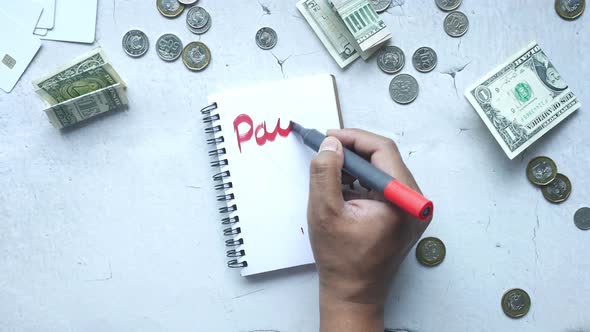 Hand Written Pay Debt Word on Notepad, Stock Footage | VideoHive