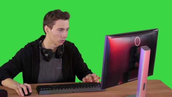 Gamer Playing a Video Game on Personal Computer on a Green Screen ...