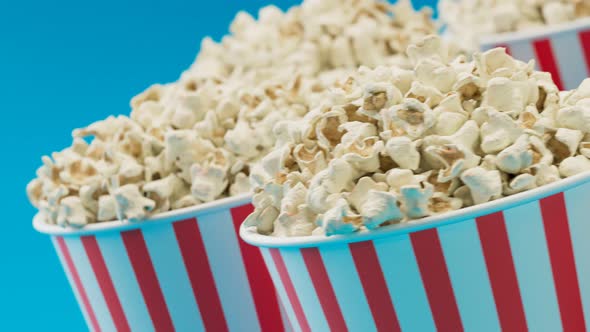 Seamless looping animation of full popcorn buckets. Boxes are spinning ...