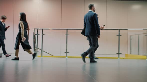 Slow Motion of People Walking in Hallway Wearing Suits, Lady Rolling ...