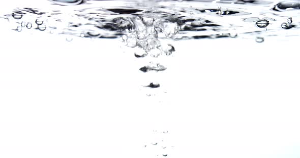 Water drips into a water surface - white background, Stock Footage