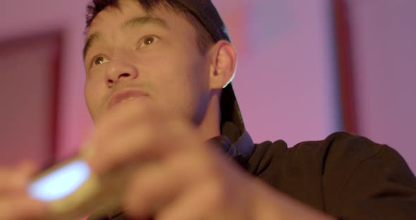 A A Male of Korean is Using a Video Game Controller, Stock Footage