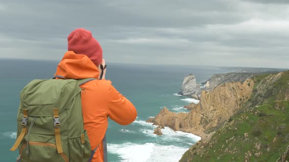 Positive Photographer Takes Picture of Ocean From Cliff, Stock Footage