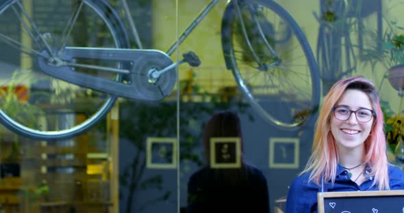 Female Owner Holding Chalkboard with Open Concept 4k, Stock Footage