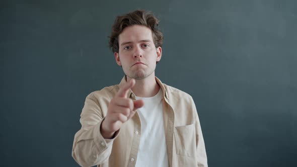 Slow Motion Portrait of Young Man Wagging Finger and Looking at Camera ...
