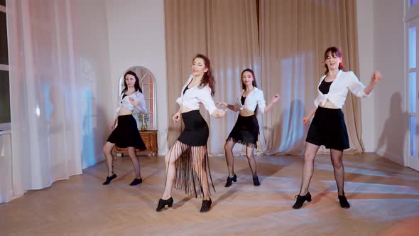 Four Girls in Black Skirts and White Shirts are Dancing Indoors, Stock ...