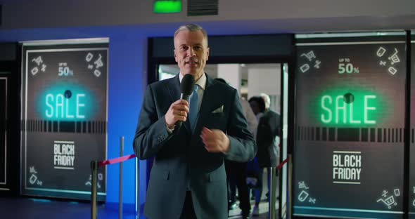 Excited Reporter Announcing Black Friday in Crazy Crowd, Stock Footage