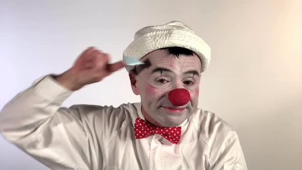 Emoji Clown - Hot and Tired Face. A mime clown with tongue stuck out ...