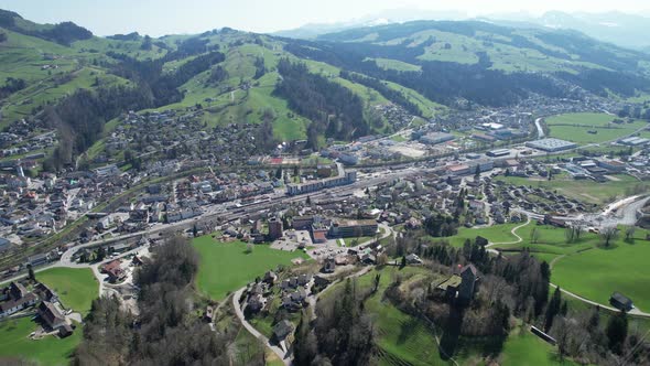 Stunning city Wattwil in the alps in Switzerland, aerial forward shot ...