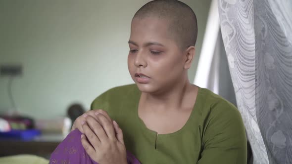 Worried and hopeless cancer patient bald Asian girl is sad and crying ...