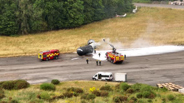 Firefighters Training to Tackle a Fire of a Dummy Aircraft, Stock Footage