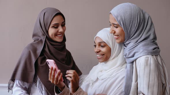 Three Muslim Girls Take Selfie on Phone Smiling and Laughing in Beige ...
