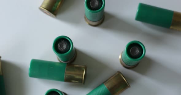 Shotgun slug shells scattered on white surface, Stock Footage | VideoHive