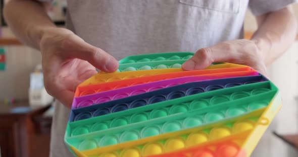 Man playing popit toy., Stock Footage | VideoHive