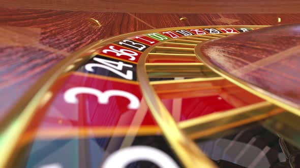 Closeup view at casino roulette table with rotating wooden roulette ...