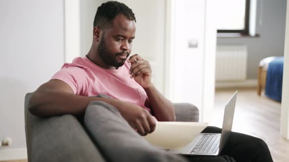 African pensive man looking at paper, Stock Footage | VideoHive