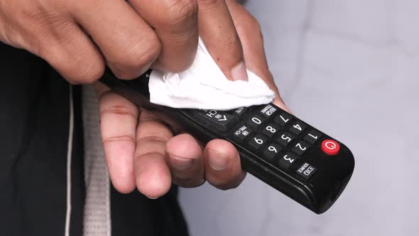 Man Hand Cleaning TV Remote Controller with Disinfectant Wet Wipe ...