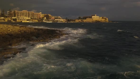 Low altitude aerial view flying forward over rolling waves as they ...