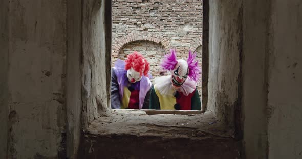 Two scary clowns look out the window, Stock Footage | VideoHive