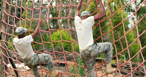 Military Soldier Climbing Rope During Obstacle Course, Stock Footage