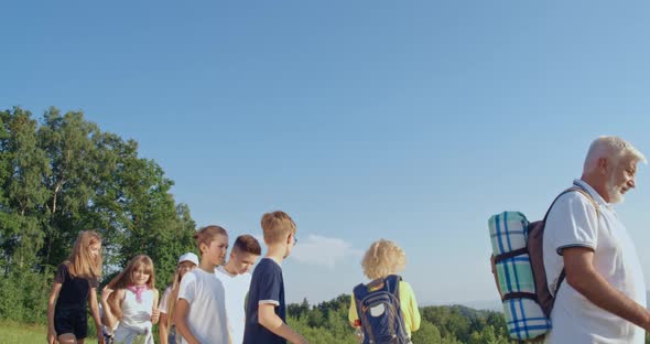 Teens with Instructor Hiking in Mountains at Warm Summer Day, Stock Footage