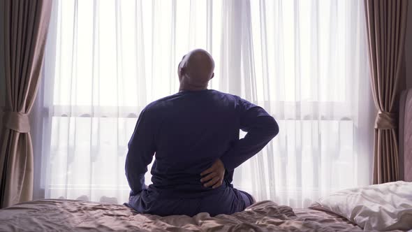 Old elderly black man. African American person waking up on bed in ...