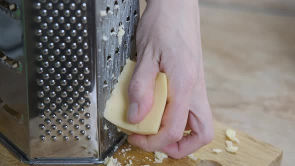 Grating cheese for bakery., Stock Footage | VideoHive