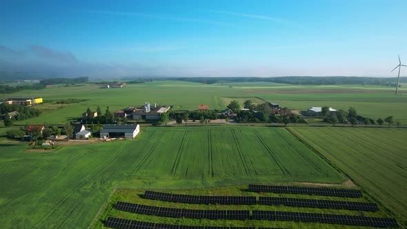 Solar panel farm in small farm town, wind mills, farm fields., Stock ...