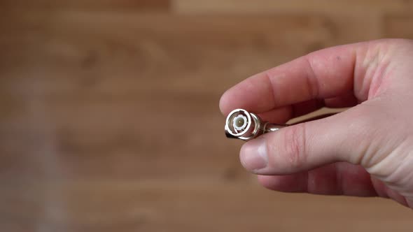 Rotation in Hand of Sdi Tee with Bnc Connector Close Up, Stock Footage