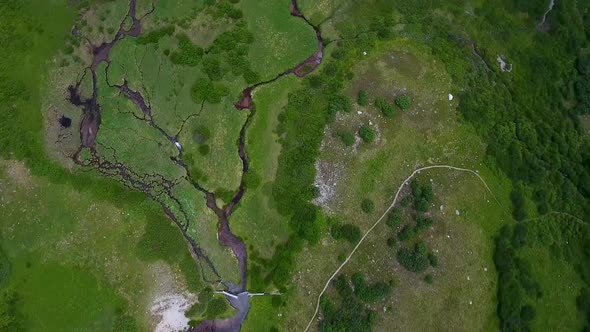 AERIAL: Birds eye view looking down at water streams surrounded by ...