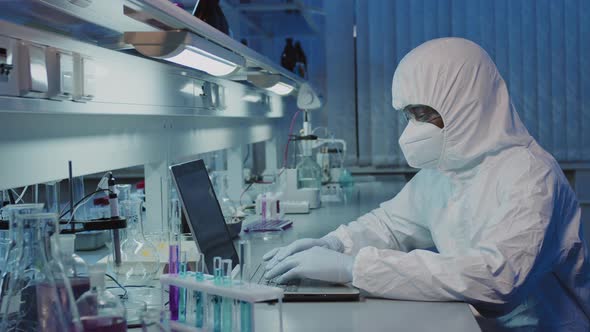 Epidemiologist in Protective Coveralls Working and Posing in Lab, Stock ...