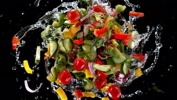Super Slow Motion Shot of Rotating Exploded Salad and Splashing Water ...