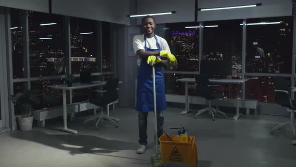 Fulllength View of Smiling AfricanAmerican Janitor Looking at Camera ...