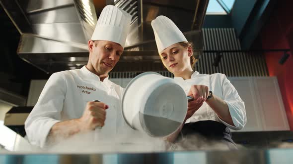 Professional kitchen: liquid nitrogen is added during the cooking of a ...