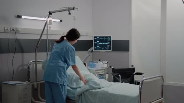 Medical Assistant Preparing Hospital Ward Bed for Patient, Stock Footage