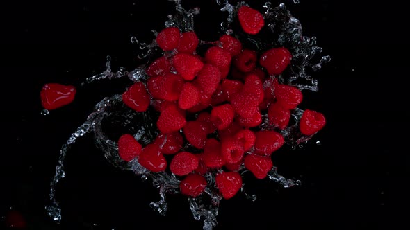 Super Slow Motion Shot of Rotating Exploded Raspberries with Splashing ...
