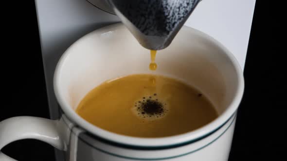 Slow motion shot of coffee drops dropping into a mug., Stock Footage