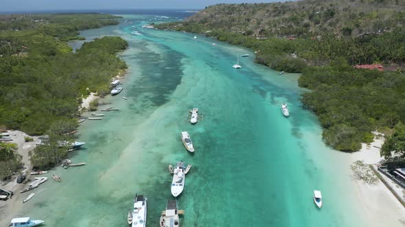 Aerial view flying backwards over a narrow ocean channel revealing a ...