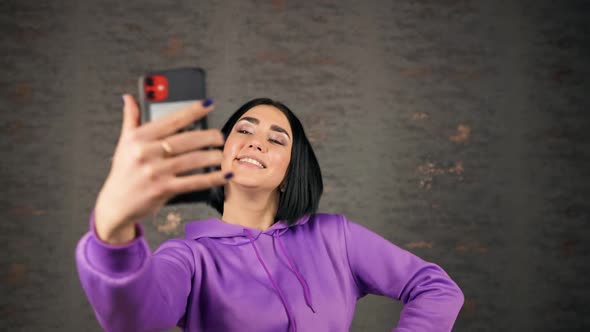 Cheerful Young Brunette Woman Takes Selfie Using Smartphone, Stock Footage